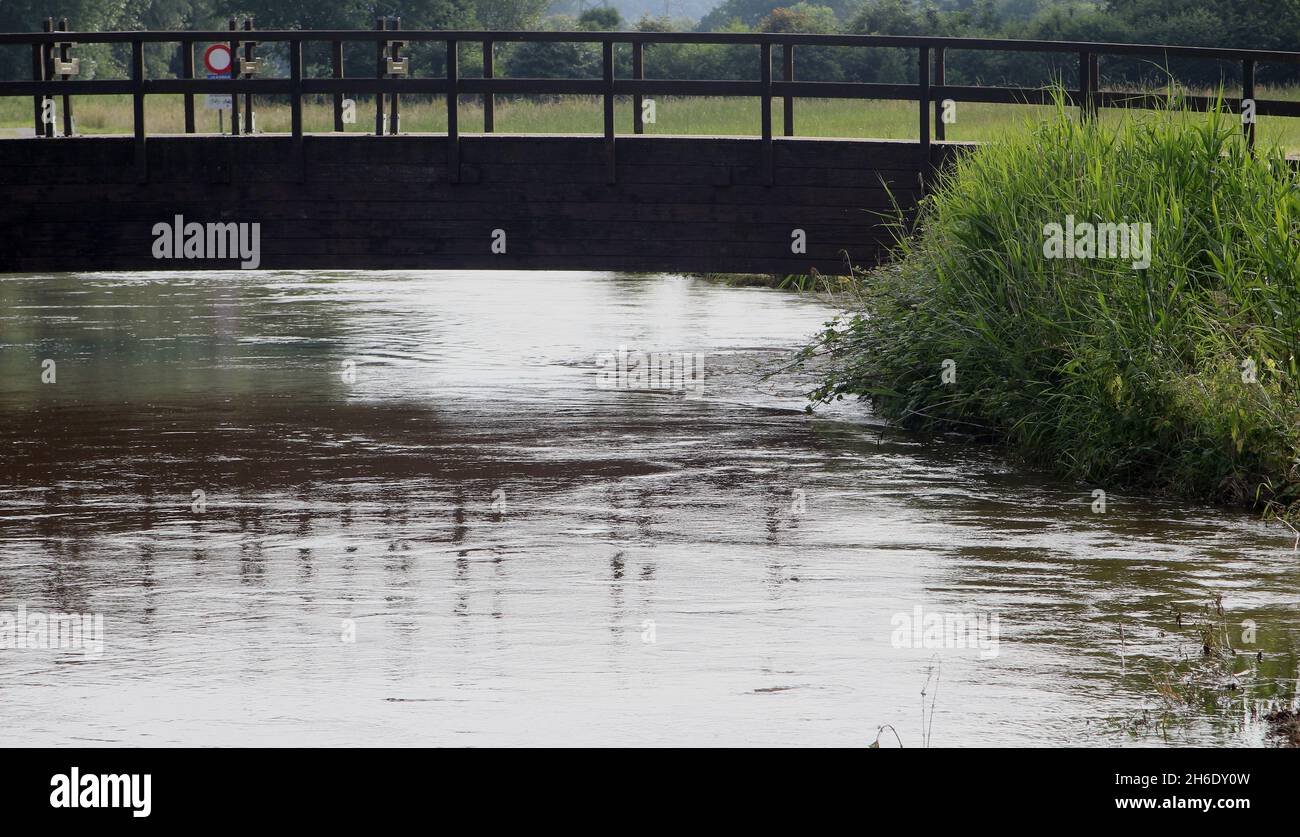 Wooden bridge over the swollen river Demer in Langdorp, Flanders ...