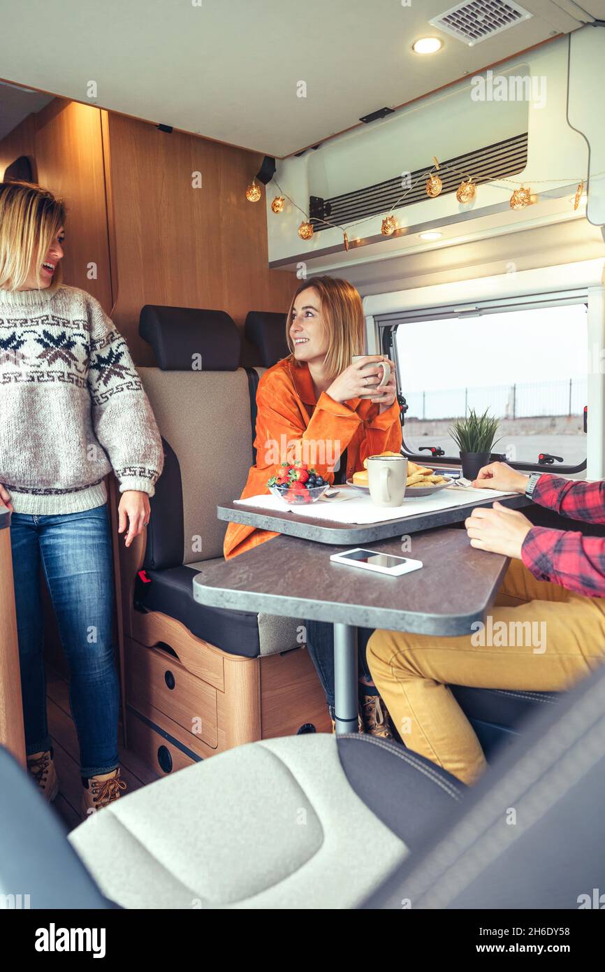 Three friends talking and having fun while drinking coffee hi-res stock ...
