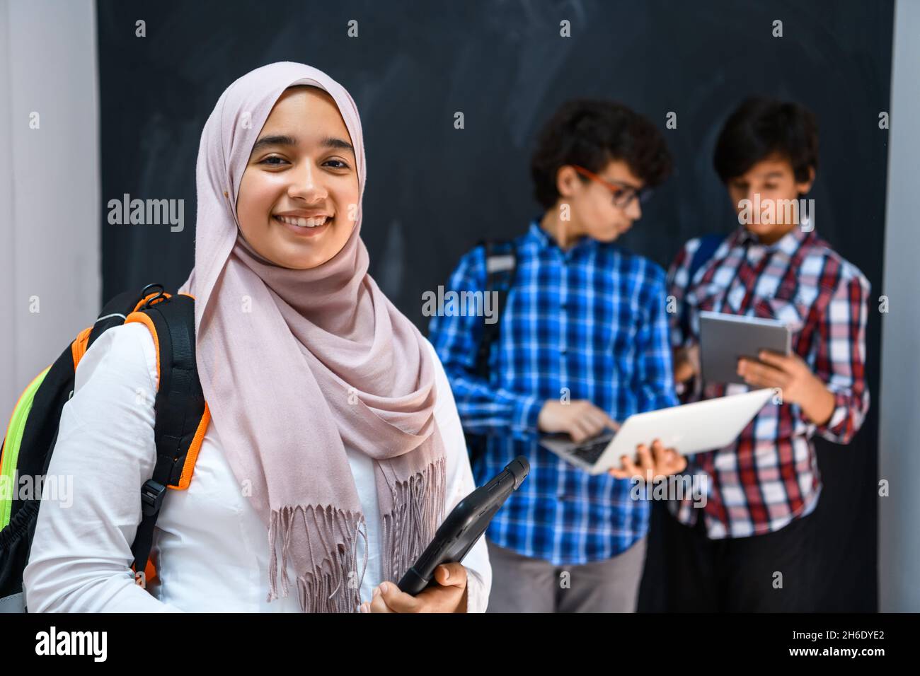 Arabic teenagers team, students group working together on laptop and ...