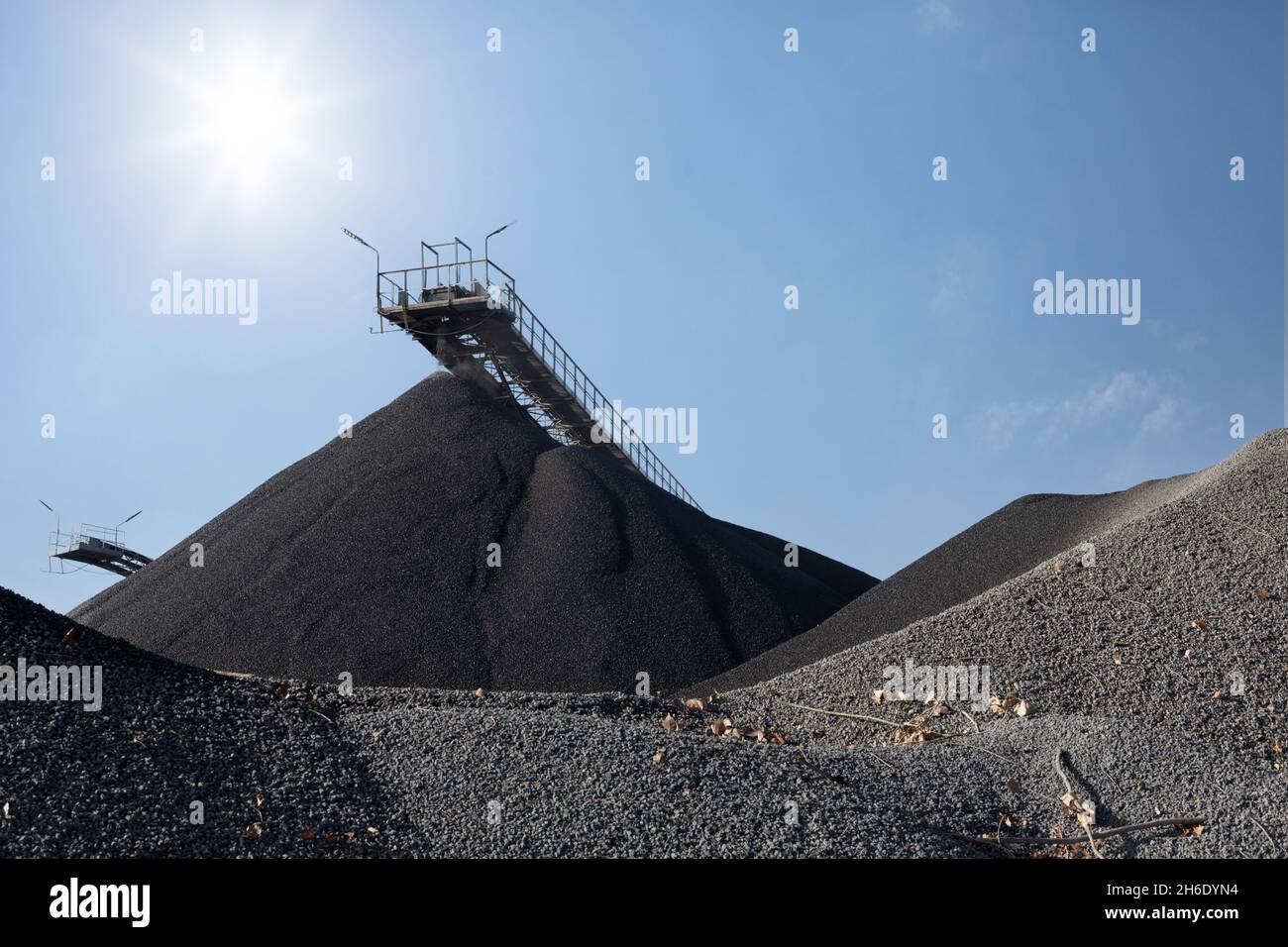 Black basalt stone mine. Mining industry. Stone top and industrial tape ...