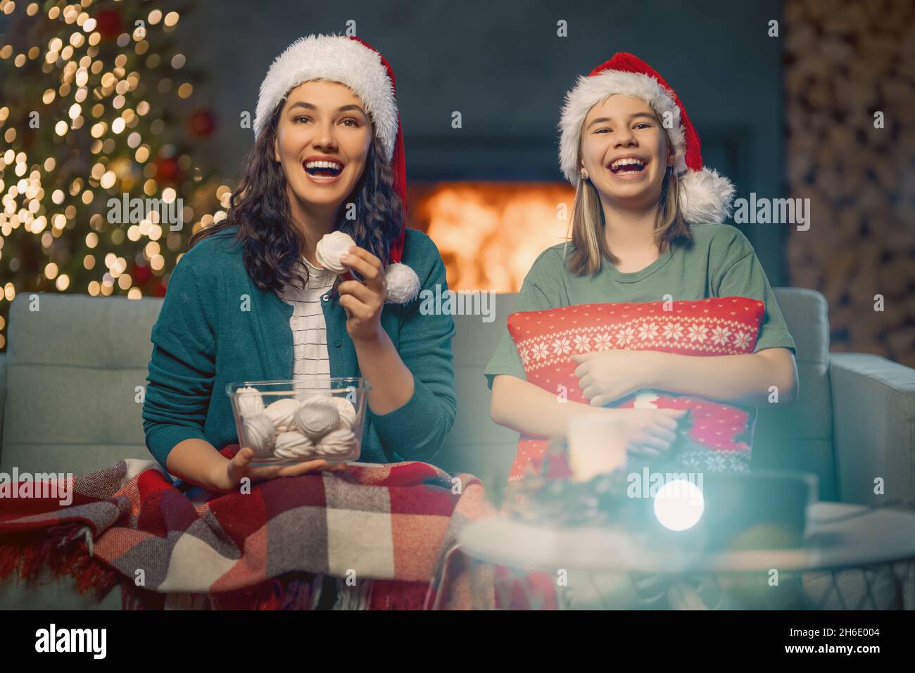 Merry Christmas and Happy New Year. People having fun near tree indoors ...