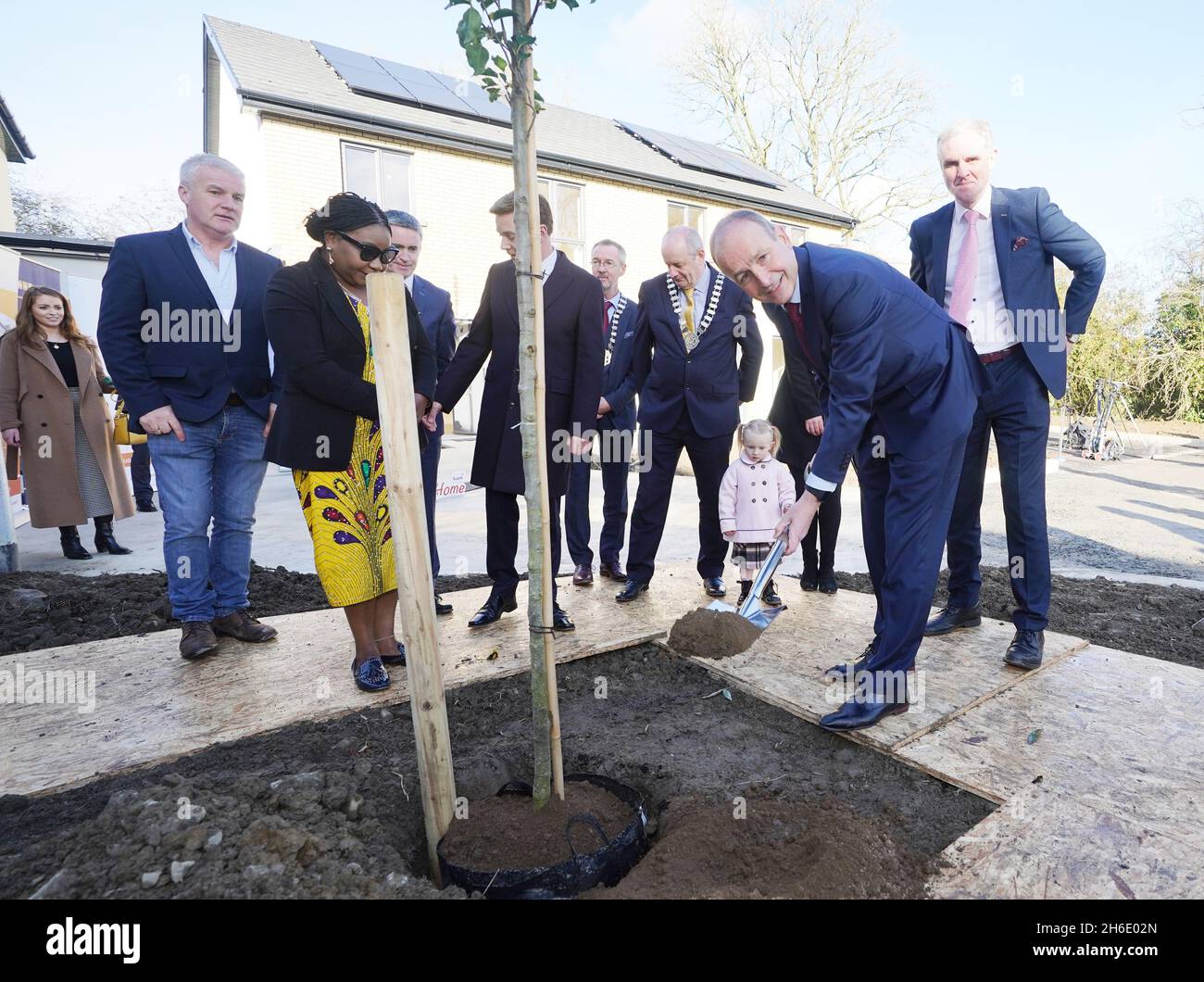 Taoiseach Micheal Martin (right) plants a tree during a visit to the ...