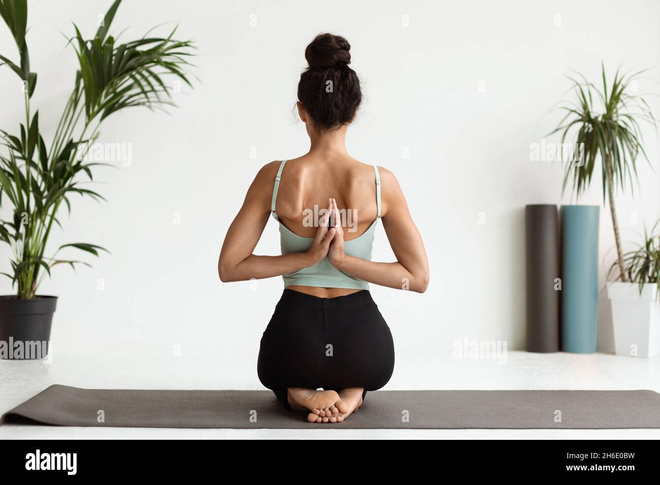 Rear View Of Young Woman Practicing Yoga, Making Reverse Prayer Pose ...