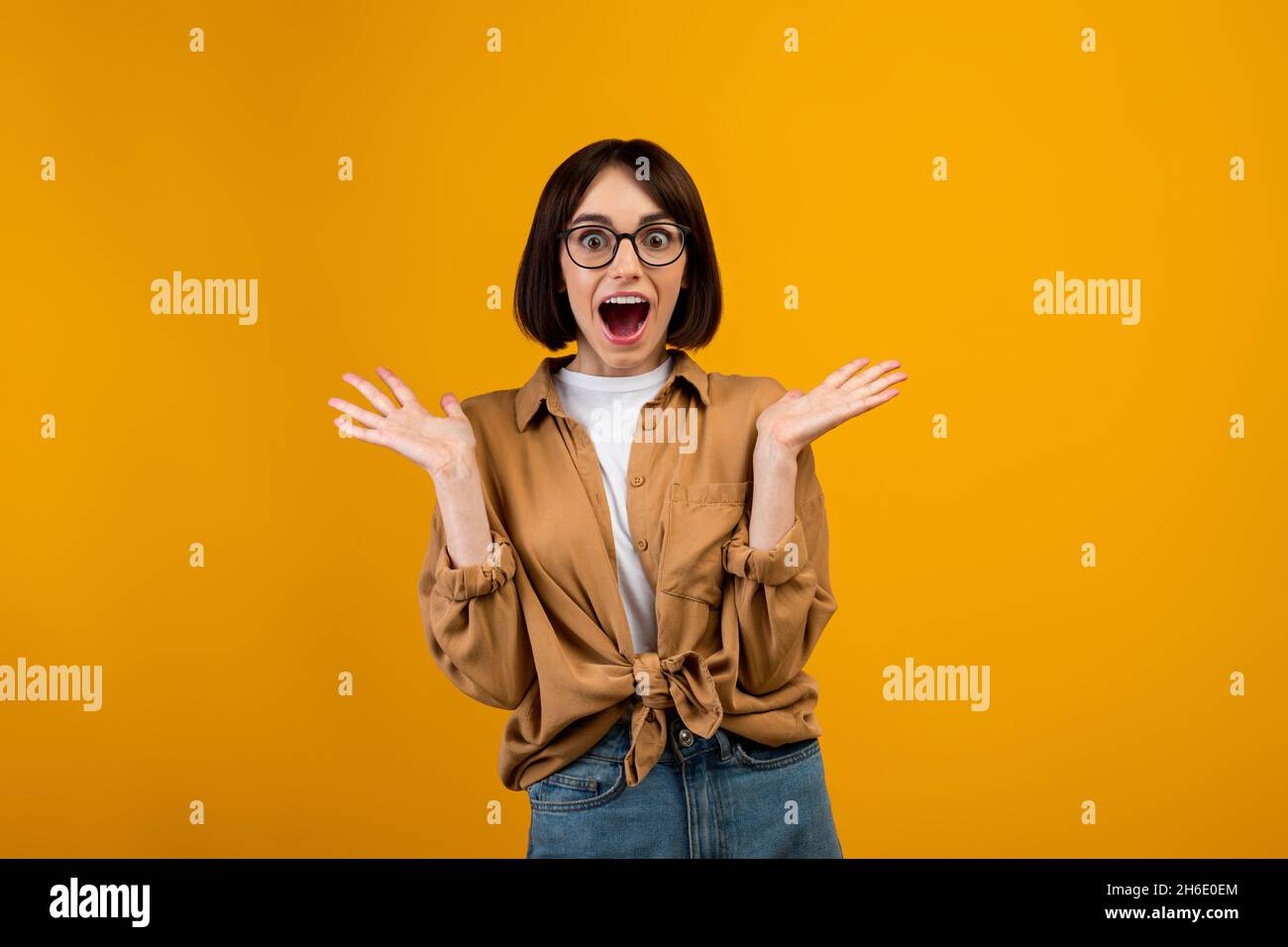 Overjoyed woman shouting WOW, screaming with joy, excited over huge ...