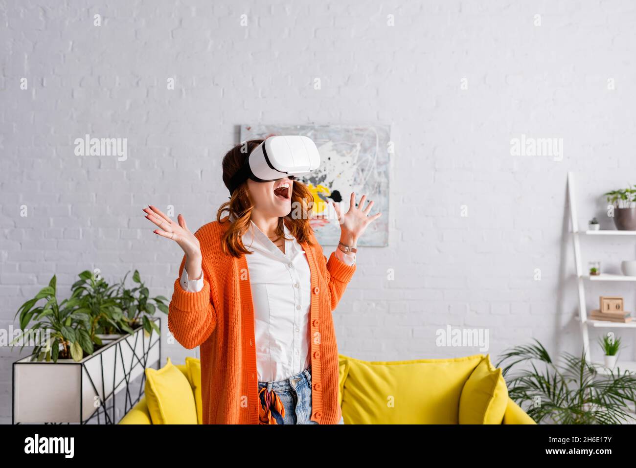 astonished woman in vr headset showing wow gesture while gaming in ...