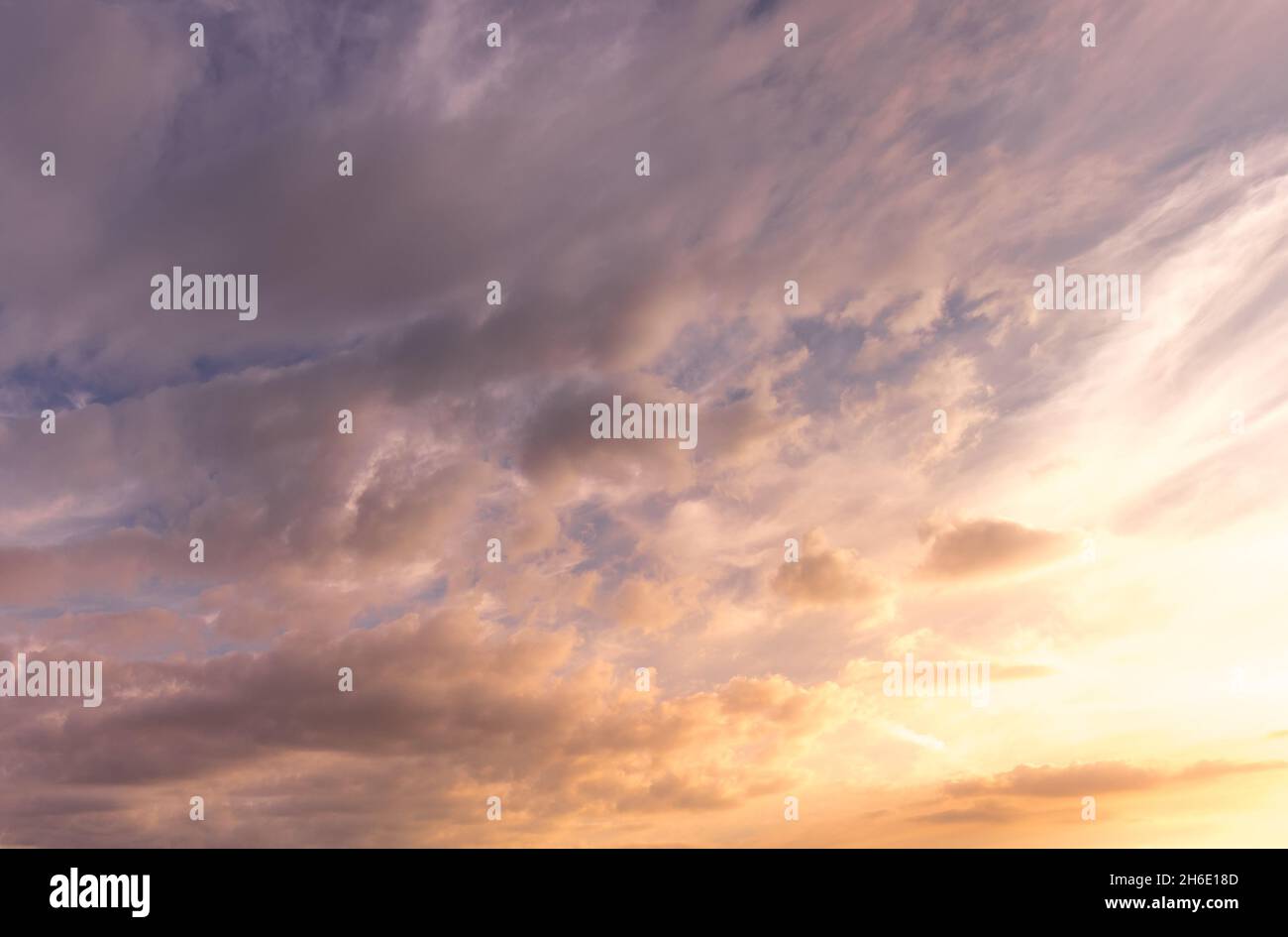 Colorful dramatic clouds lit by a sun against the sunset or sunrise sky ...