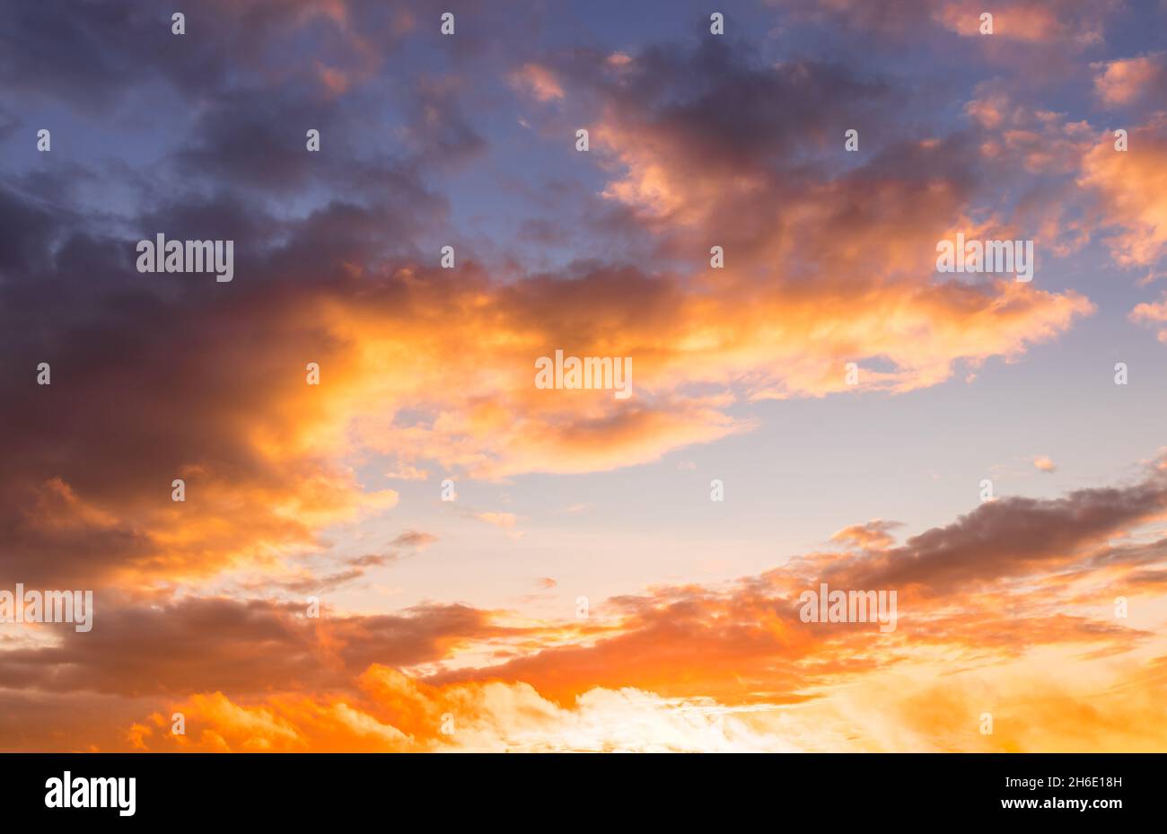 Colorful dramatic clouds lit by a sun against the sunset or sunrise sky ...