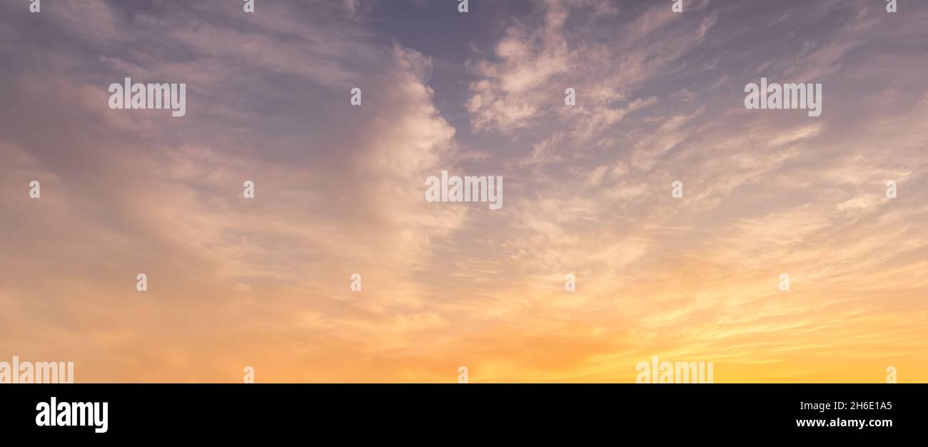 Colorful dramatic clouds lit by a sun against the sunset or sunrise sky ...