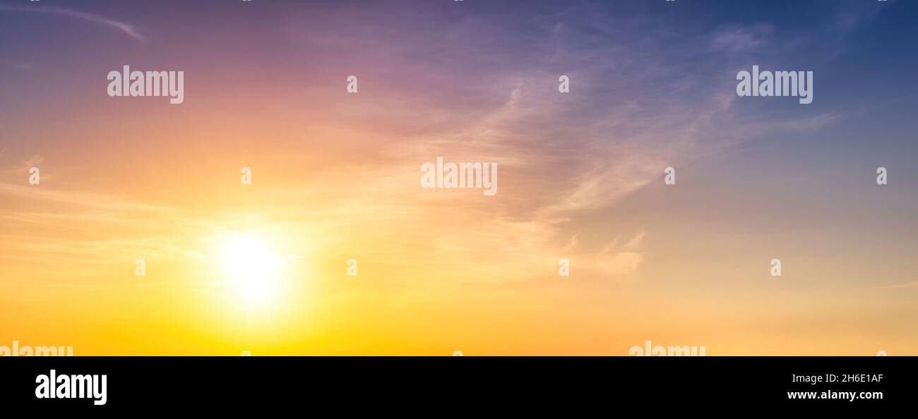 Colorful dramatic clouds lit by a sun against the sunset or sunrise sky ...