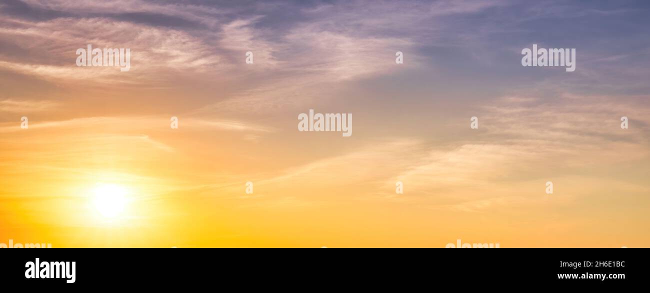 Colorful dramatic clouds lit by a sun against the sunset or sunrise sky ...