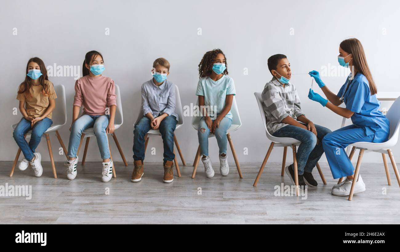 Nurse Testing Diverse Children For Covid-19 Making PCR Test Indoor ...