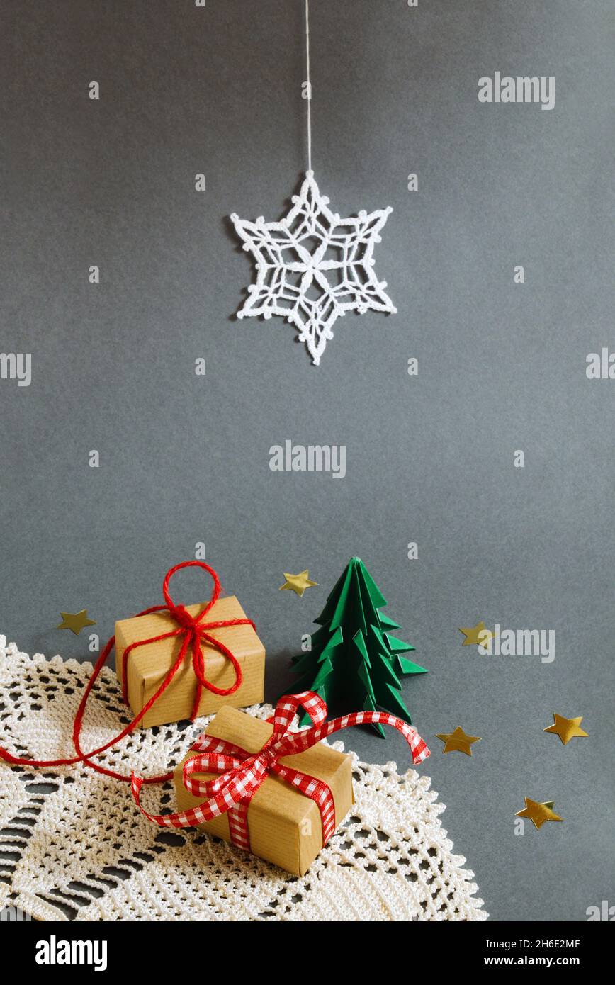Origami Christmas tree and paper gift boxes with red ribbons on lace ...