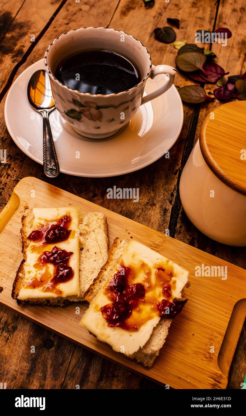 Vertical closeup of a cup of coffee and toast with jam Stock Photo - Alamy