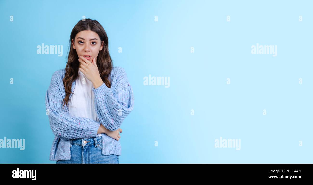 Portrait of young emotional girl posing isolated on navy color studio ...