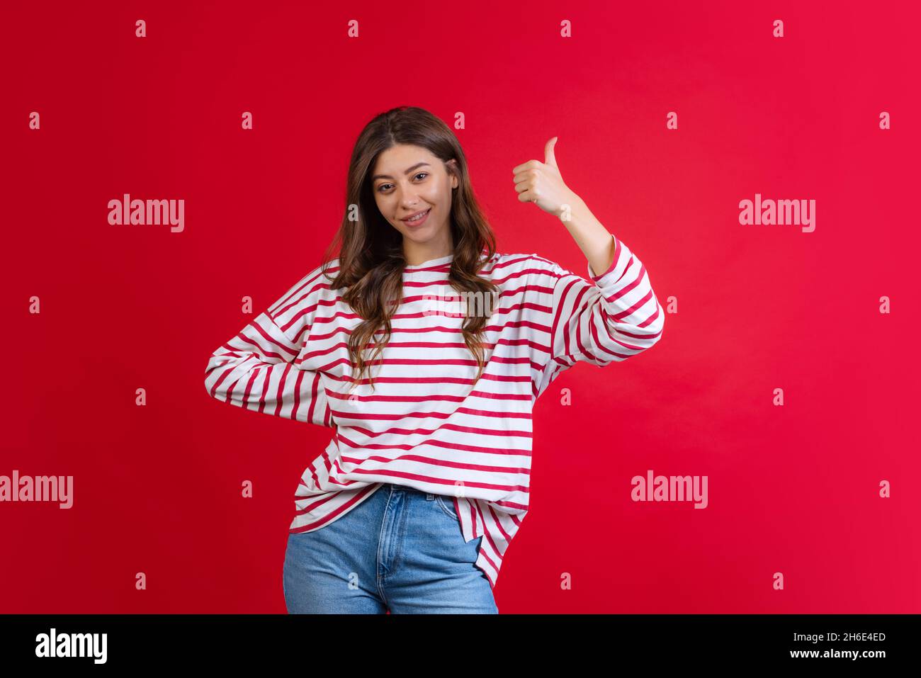 Emotional young beautiful girl in sweater and jeans posing isolated on ...
