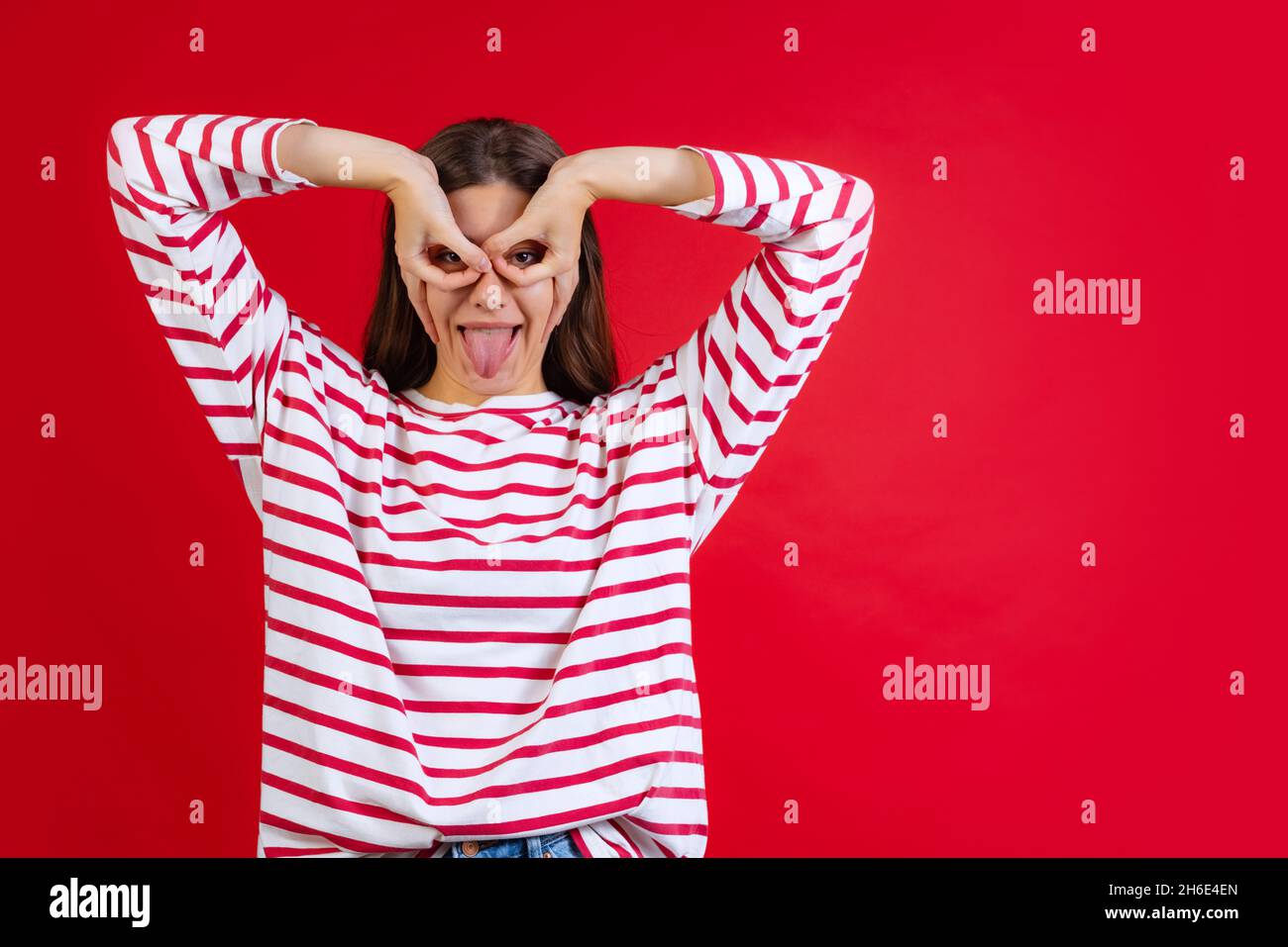 Emotional young beautiful girl in sweater and jeans posing isolated on ...