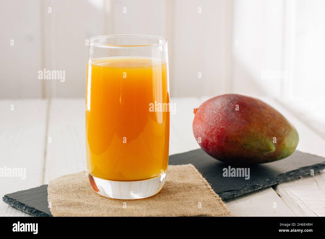 Mango juice in the glass, fresh fruit drink Stock Photo - Alamy