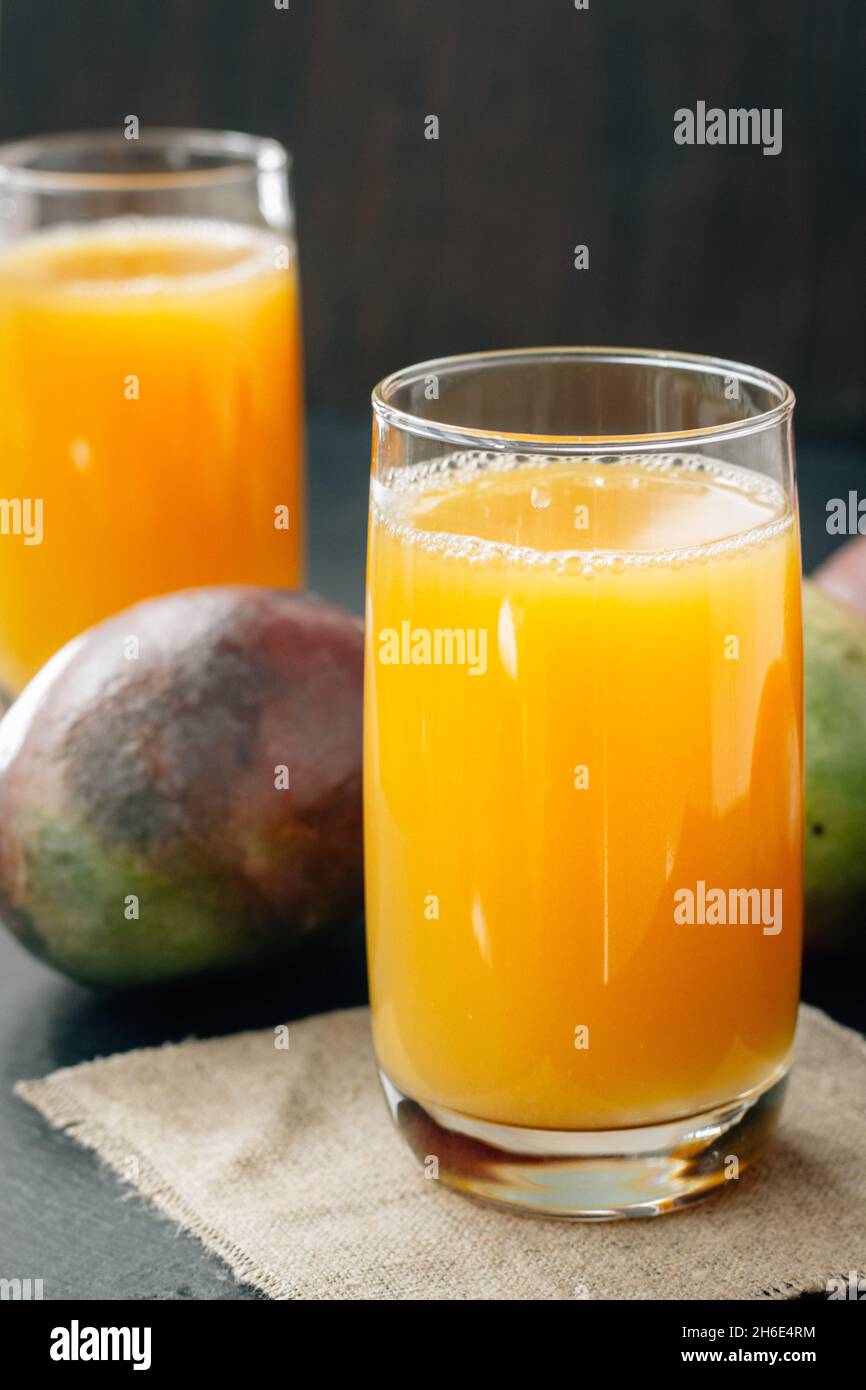 Pouring mango smoothie in glass hi-res stock photography and images - Alamy