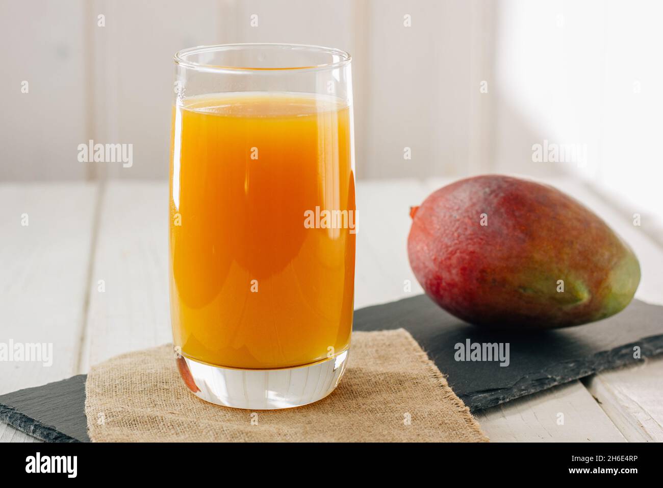 Mango juice in the glass, fresh fruit drink Stock Photo - Alamy