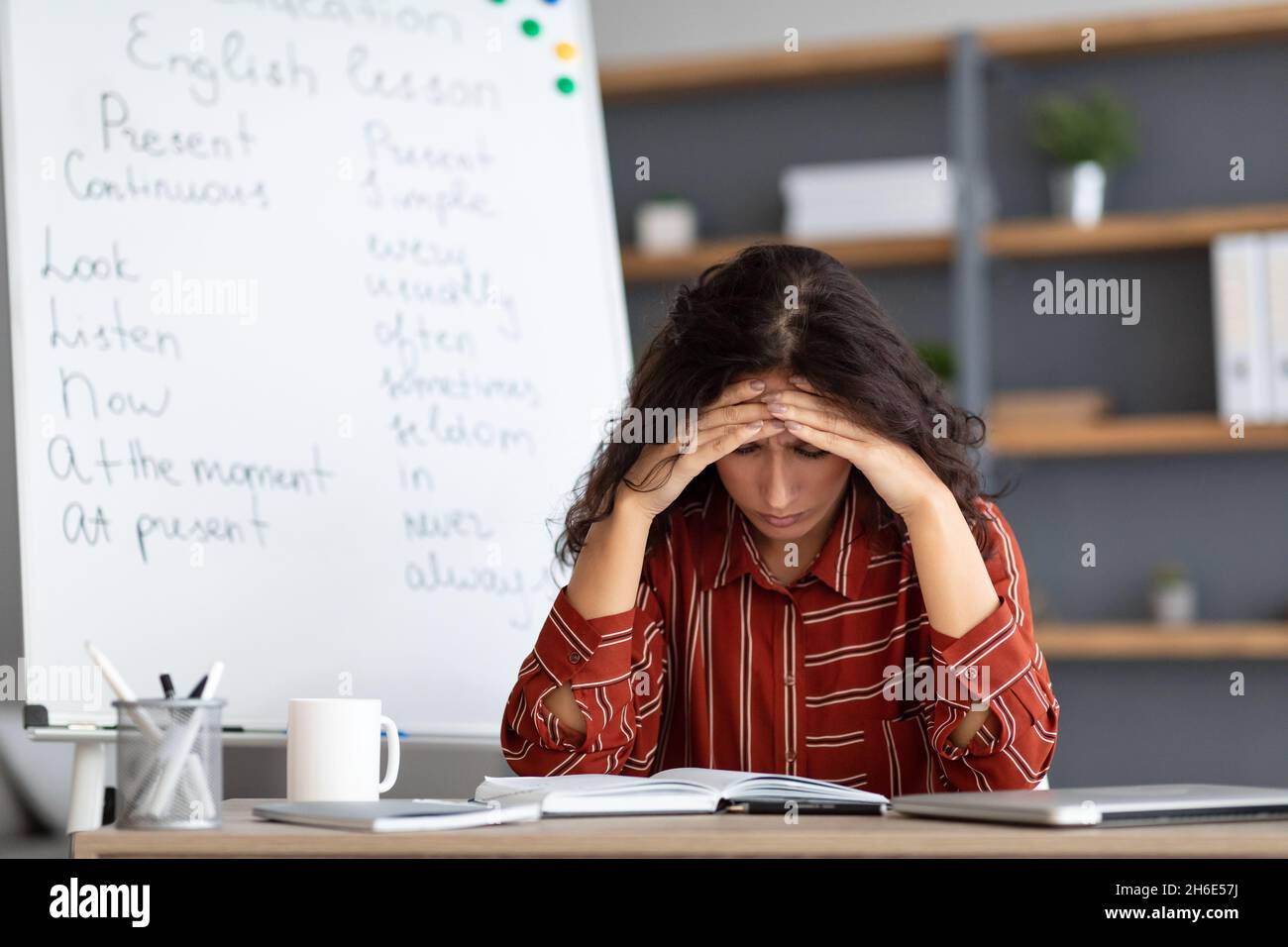 Tired teacher sitting at desk thinking about problems Stock Photo - Alamy