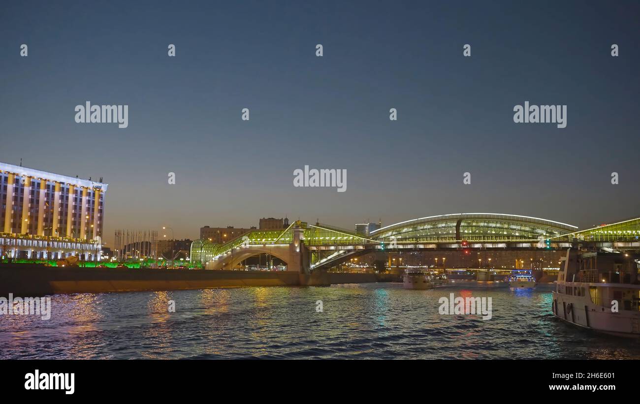 Beautiful glowing buildings on embankment. Action. Boat trip along city ...