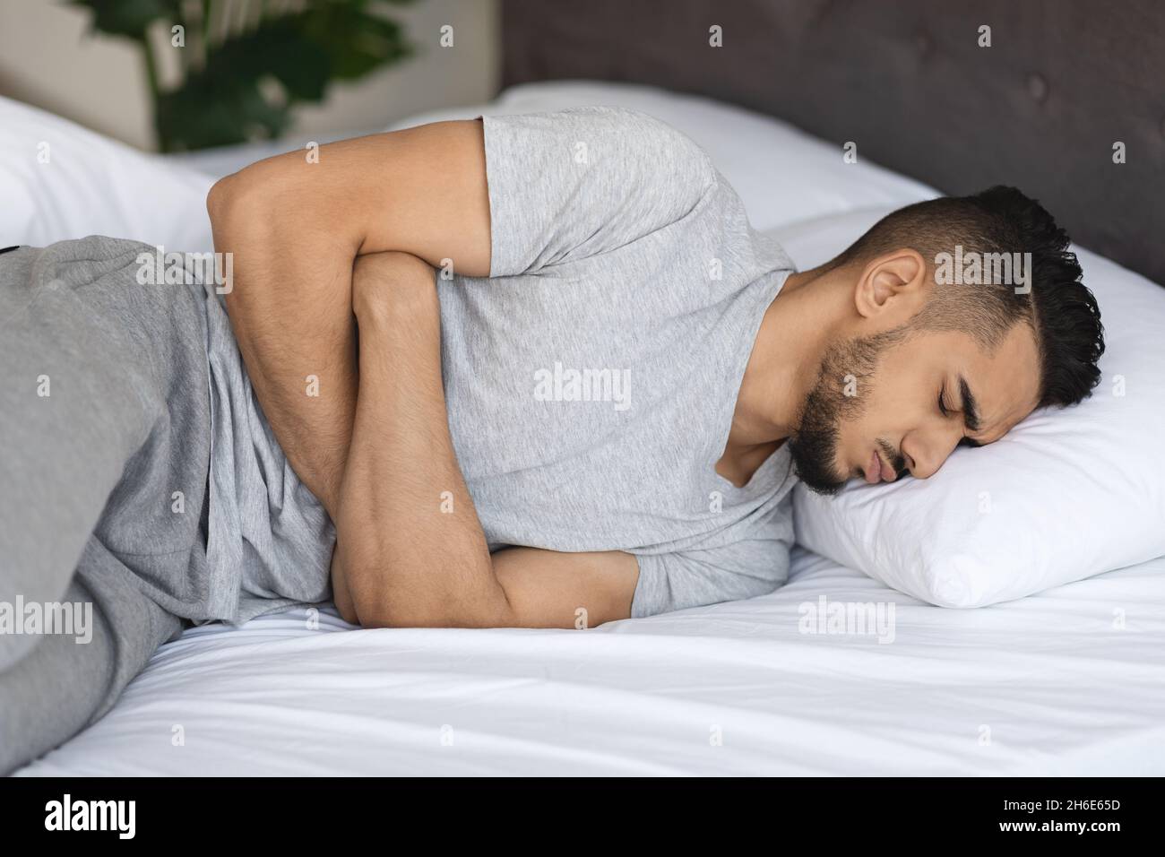Abdominal Pain. Young Arab Man Suffering Stomach Ache At Home Stock ...