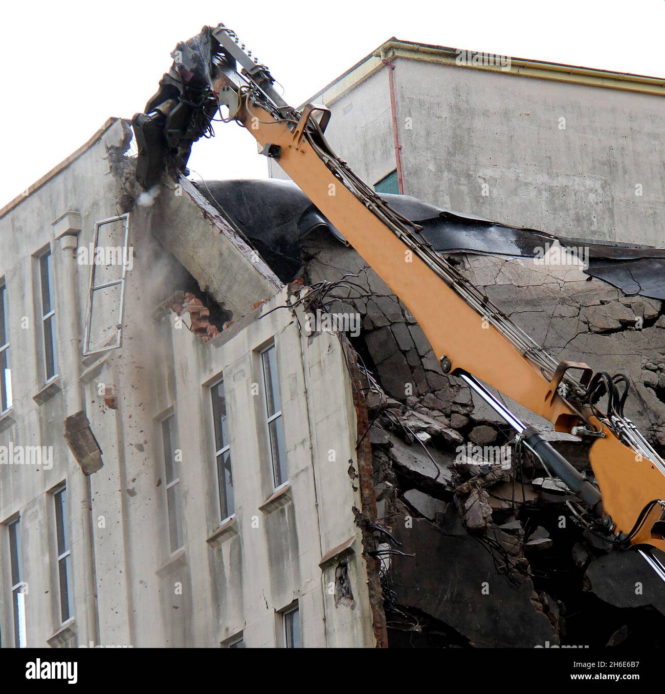 Debris Falling as a Tall Building is Demolished Stock Photo - Alamy