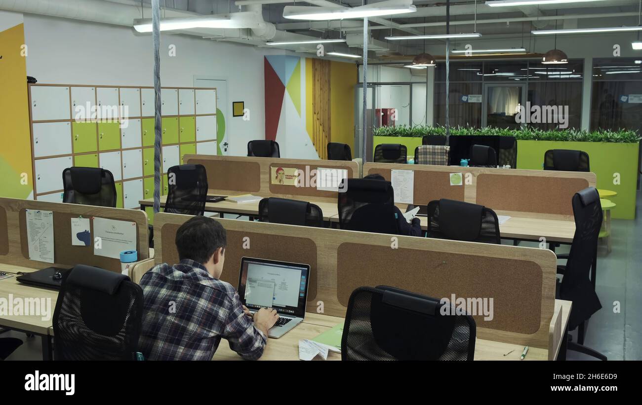 Almost empty open space office with bright walls with comfortable ...