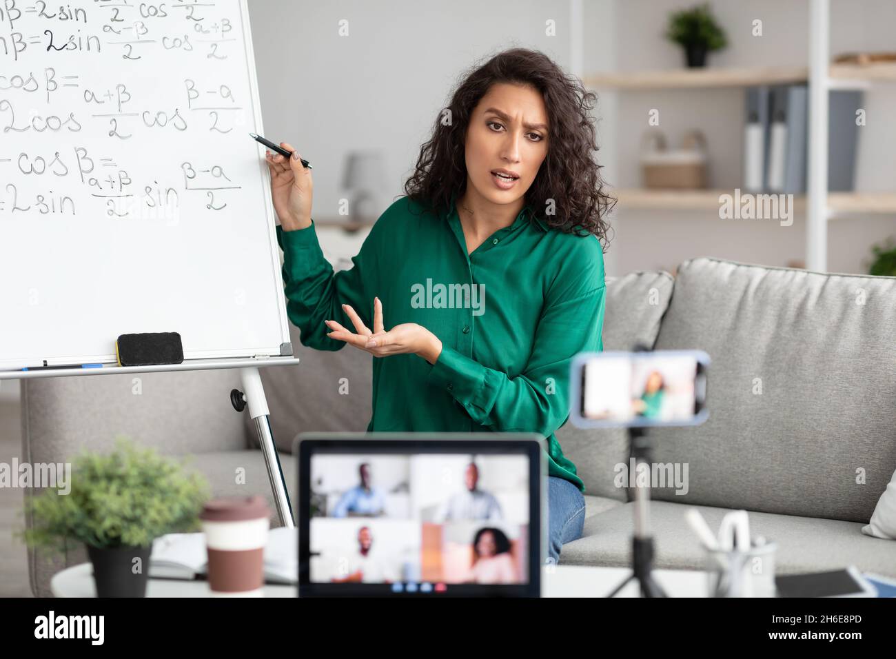 Math teacher giving virtual lecture to students Stock Photo - Alamy