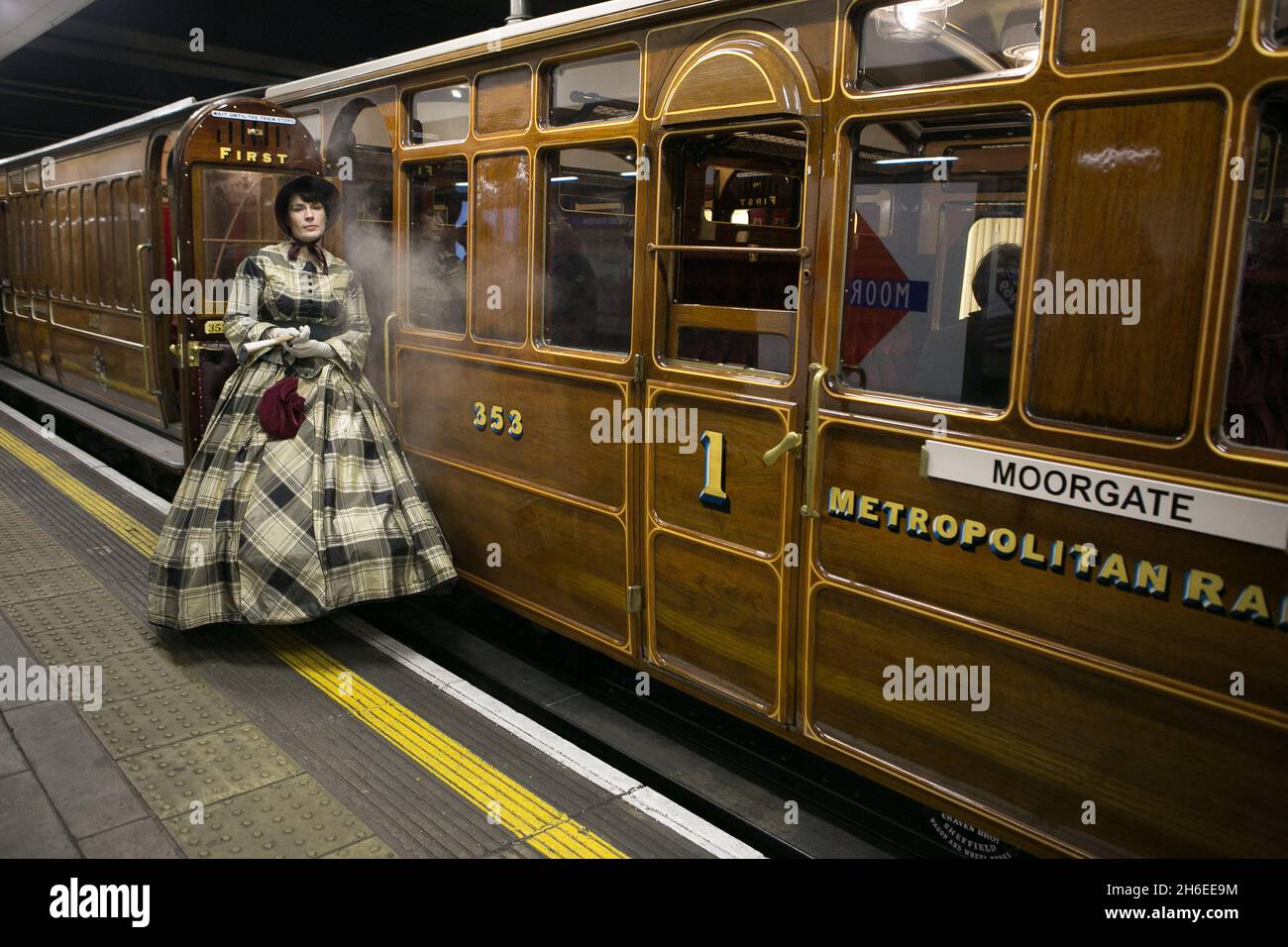 A woman in Victorian dress rides a steam train on its journey from ...