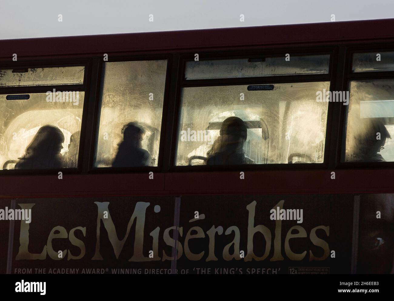 A steamed up bus full of commuters crosses Westminster bridge in London ...