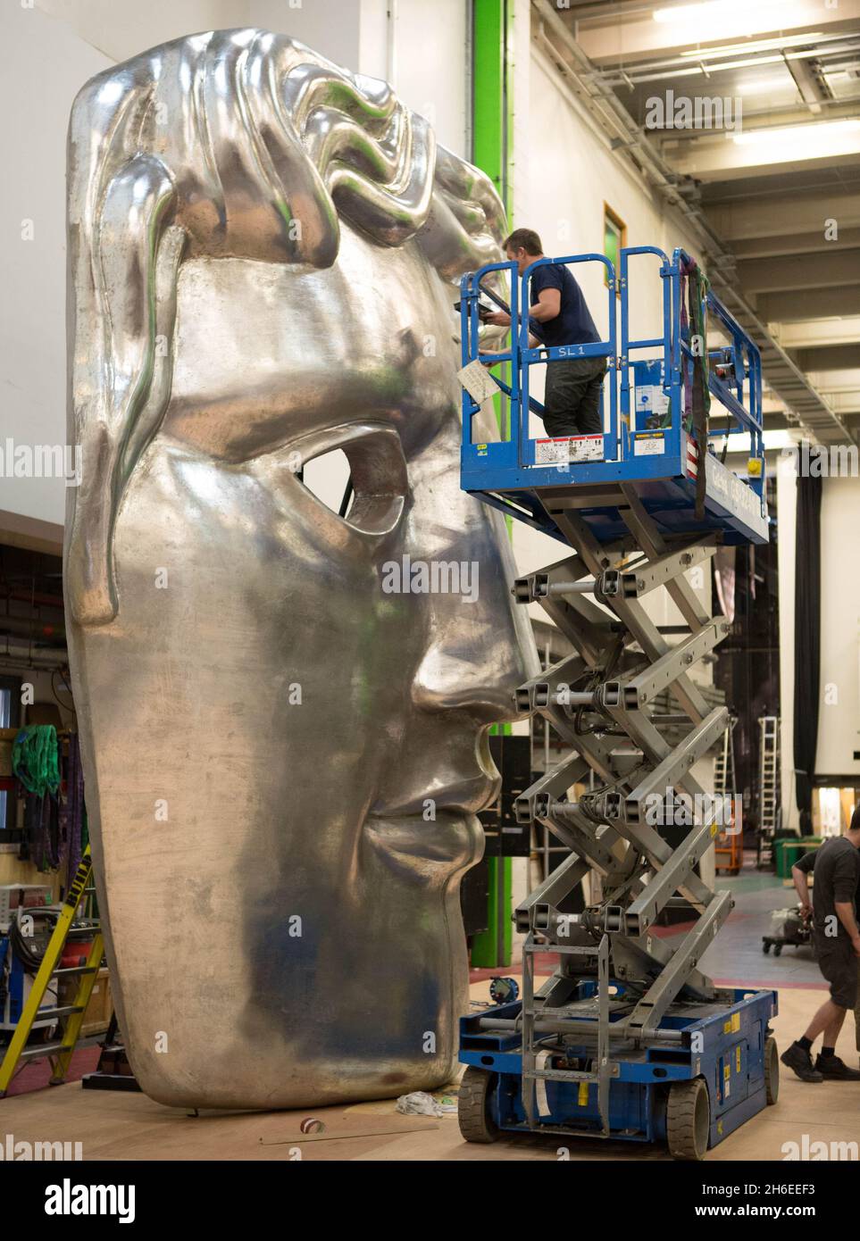 Finishes touches are made to the BAFTA stage set backstage at the Royal ...