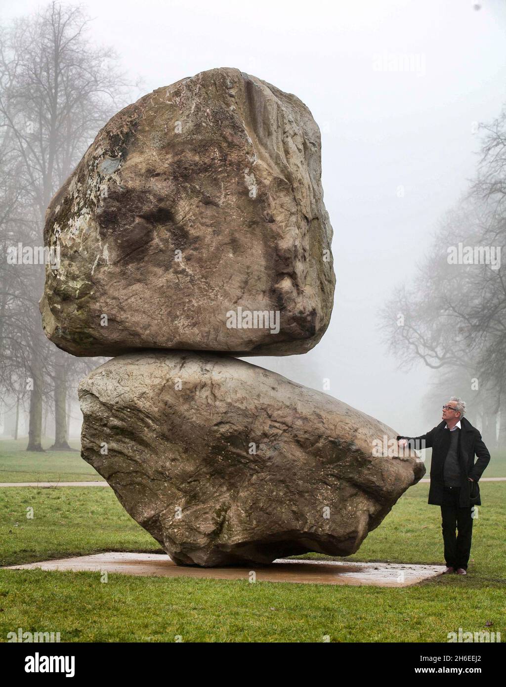 Peter Fischli stands in front of his giant boulder sculpture by him and ...