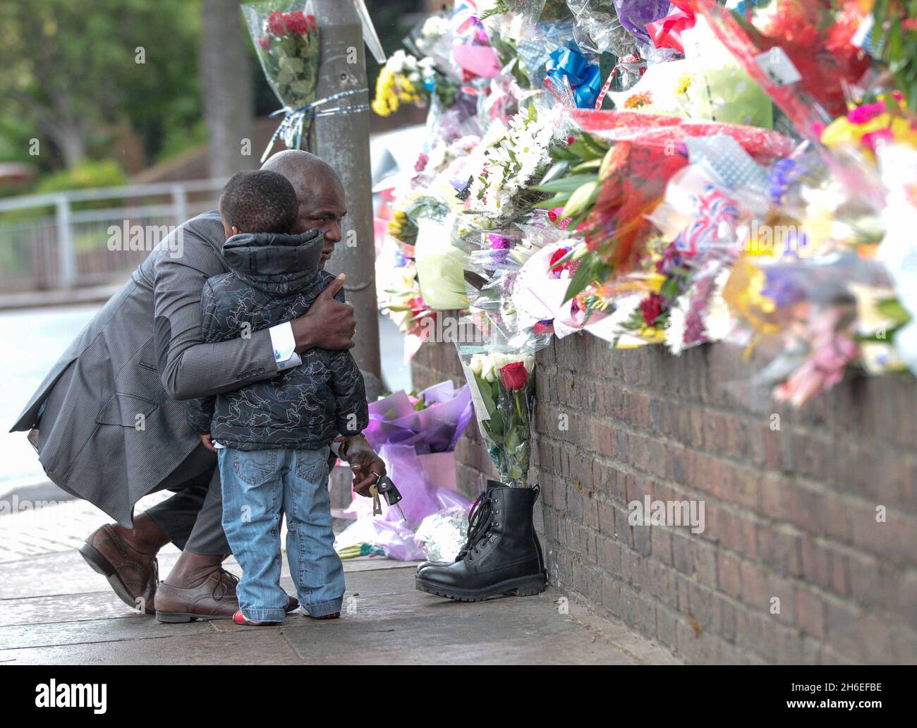 The public leave tributes and flowers at the scene where the soldier ...