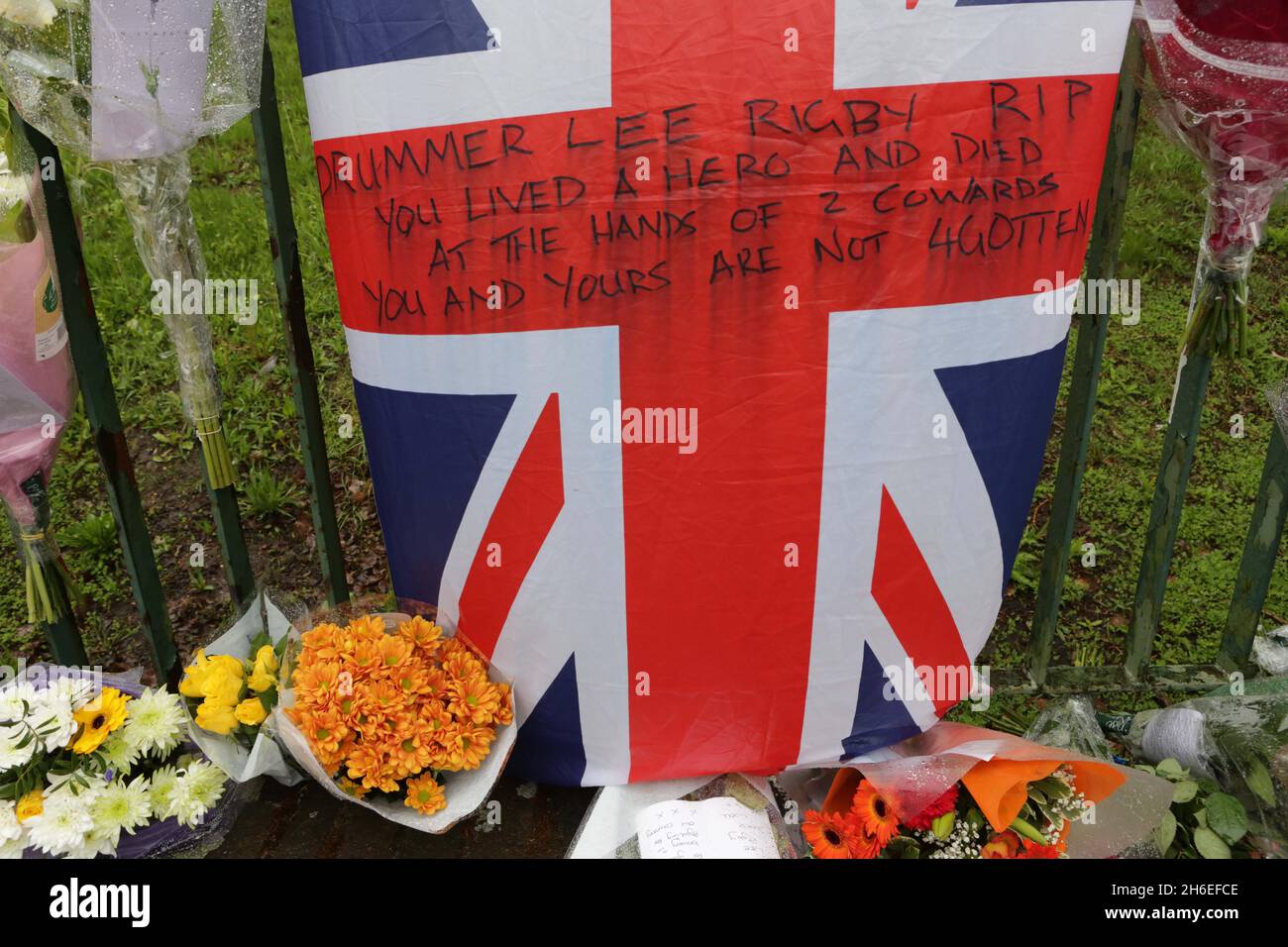 The public leave tributes and flowers at the scene where the soldier ...