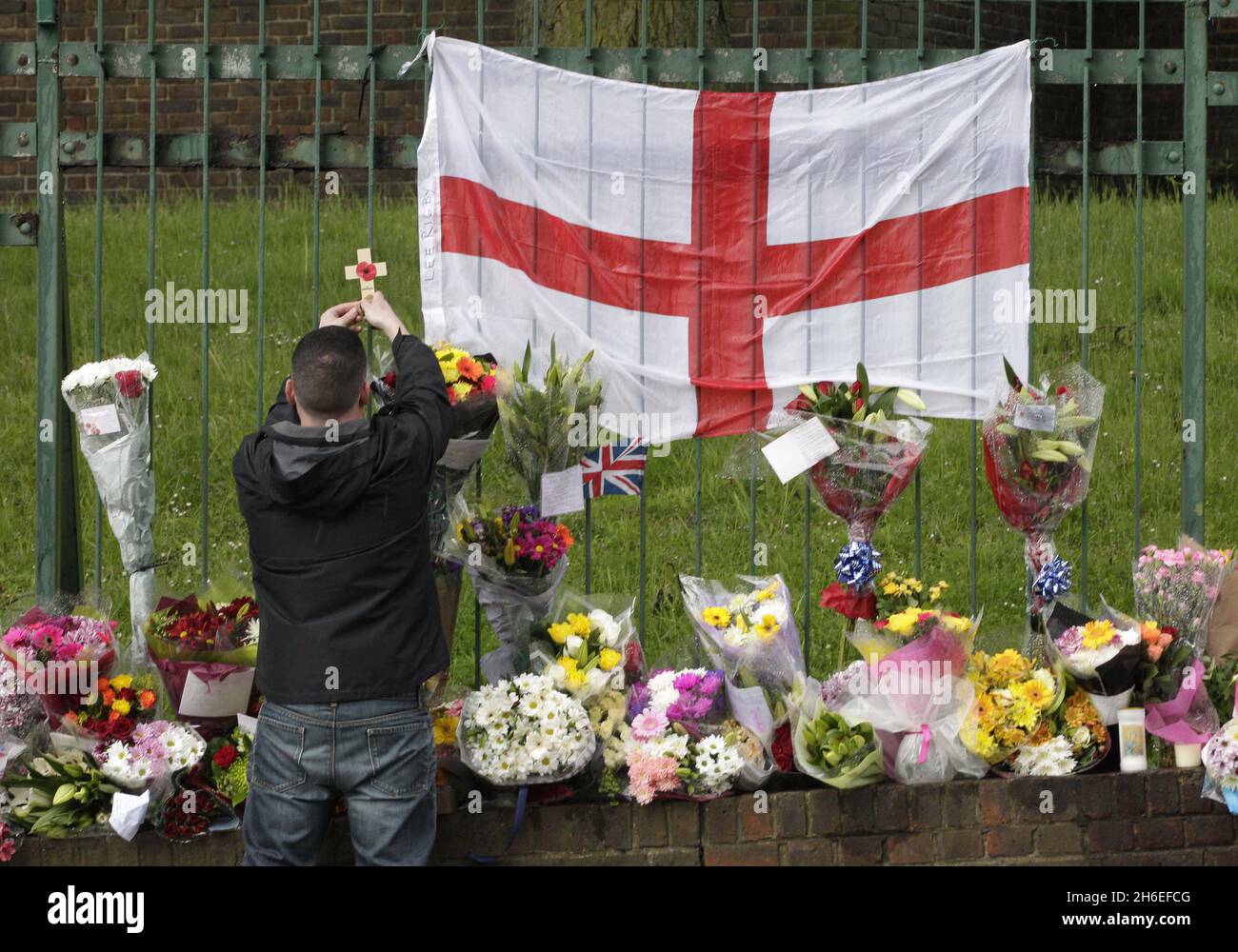 The public leave tributes and flowers at the scene where the soldier ...