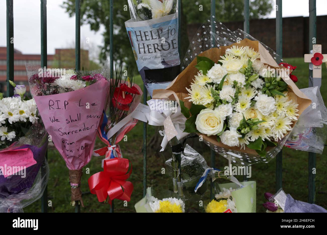 The public leave tributes and flowers at the scene where the soldier ...