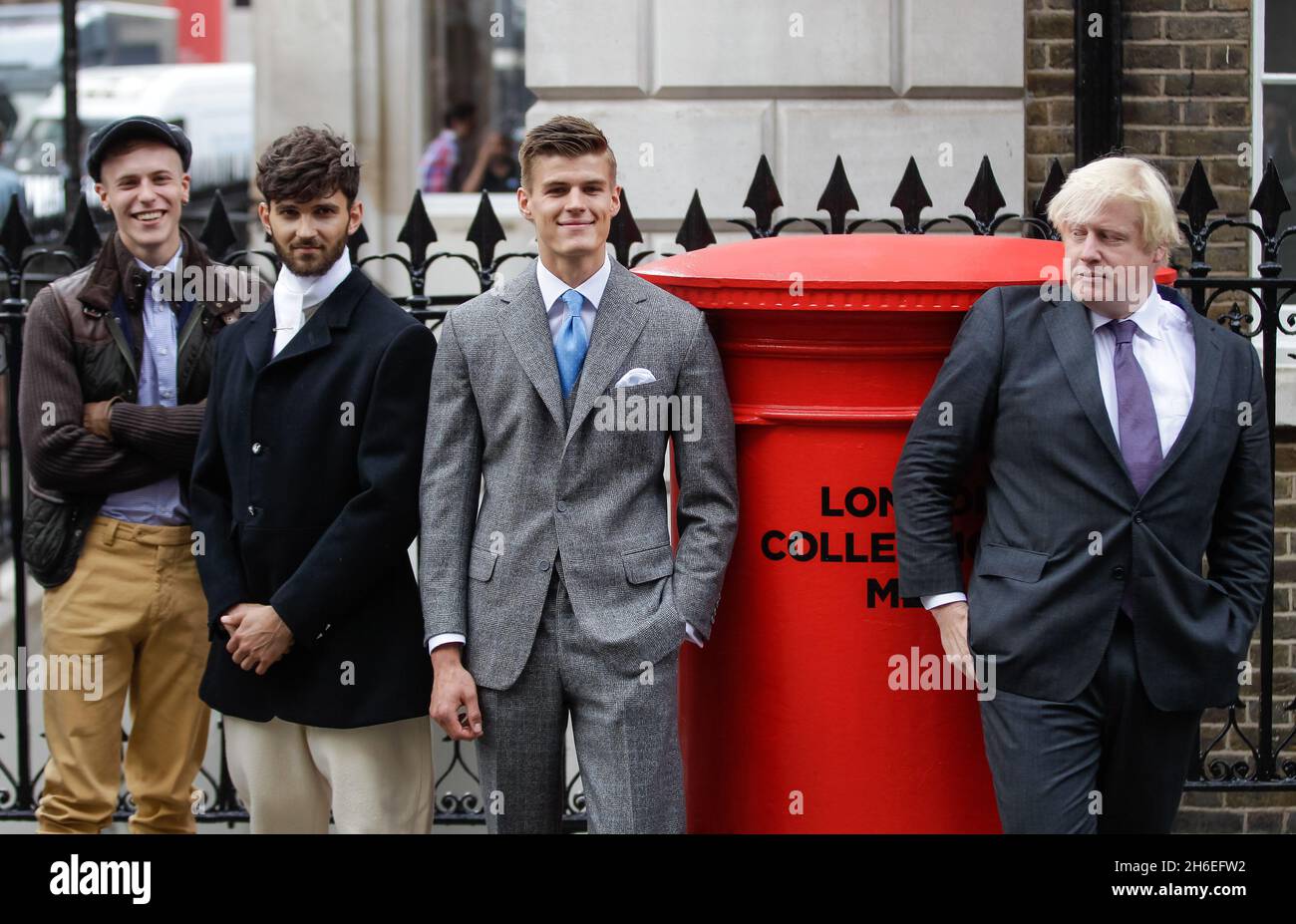 Boris Johnson attending a photocall on Savile Row, alongside nine male ...
