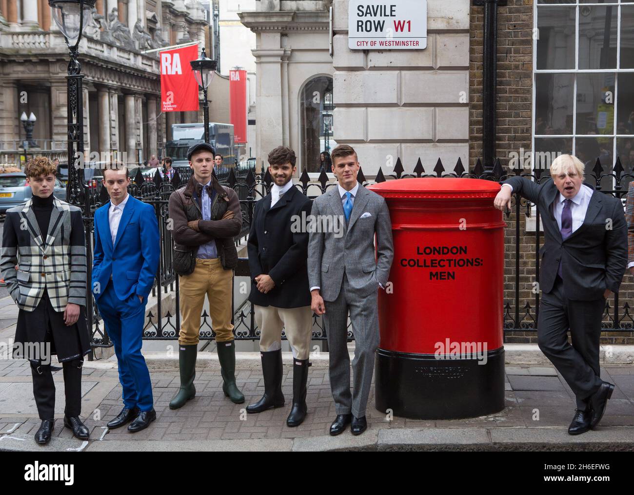 Boris Johnson attending a photocall on Savile Row, alongside nine male ...