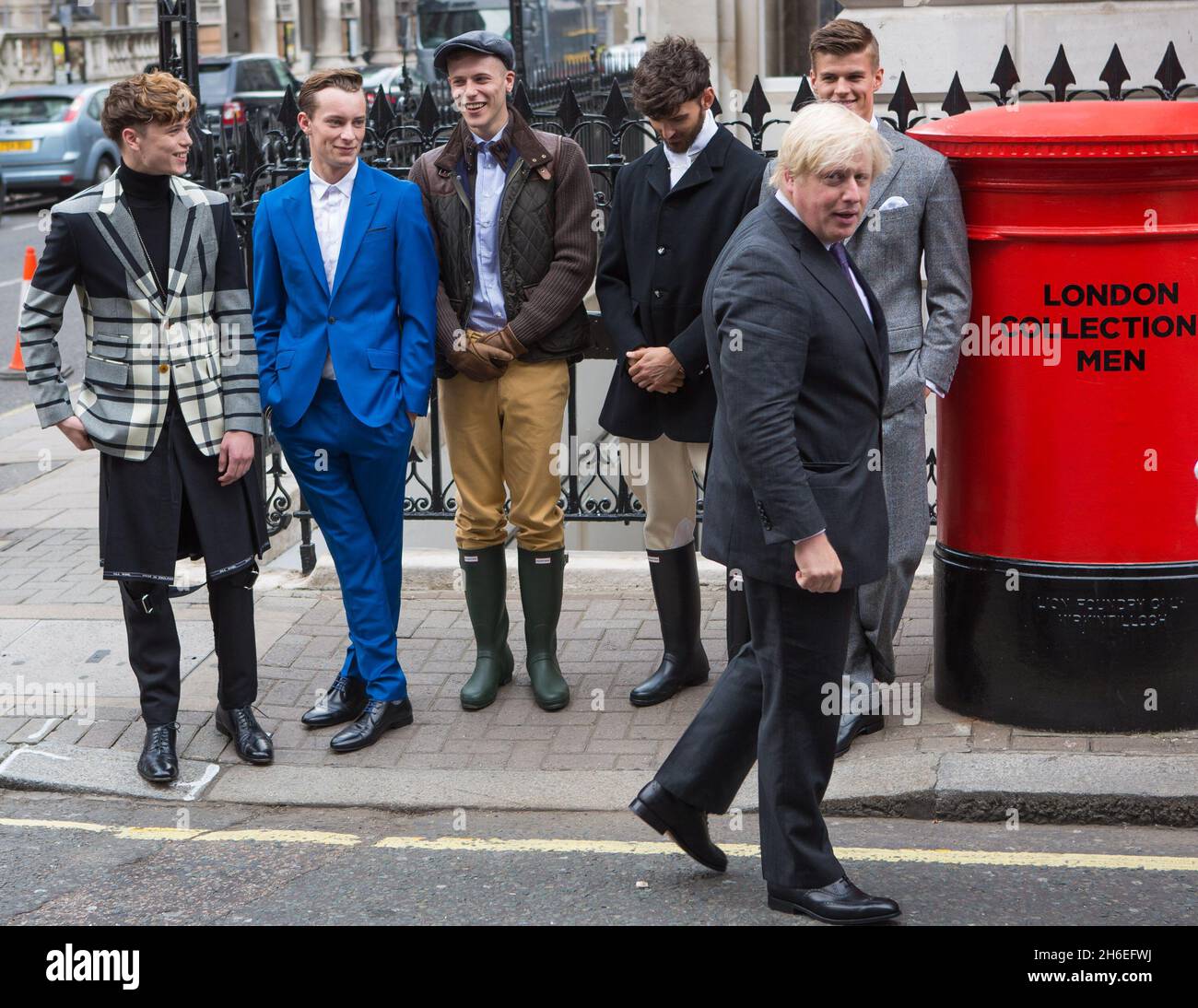 Boris Johnson attending a photocall on Savile Row, alongside nine male ...