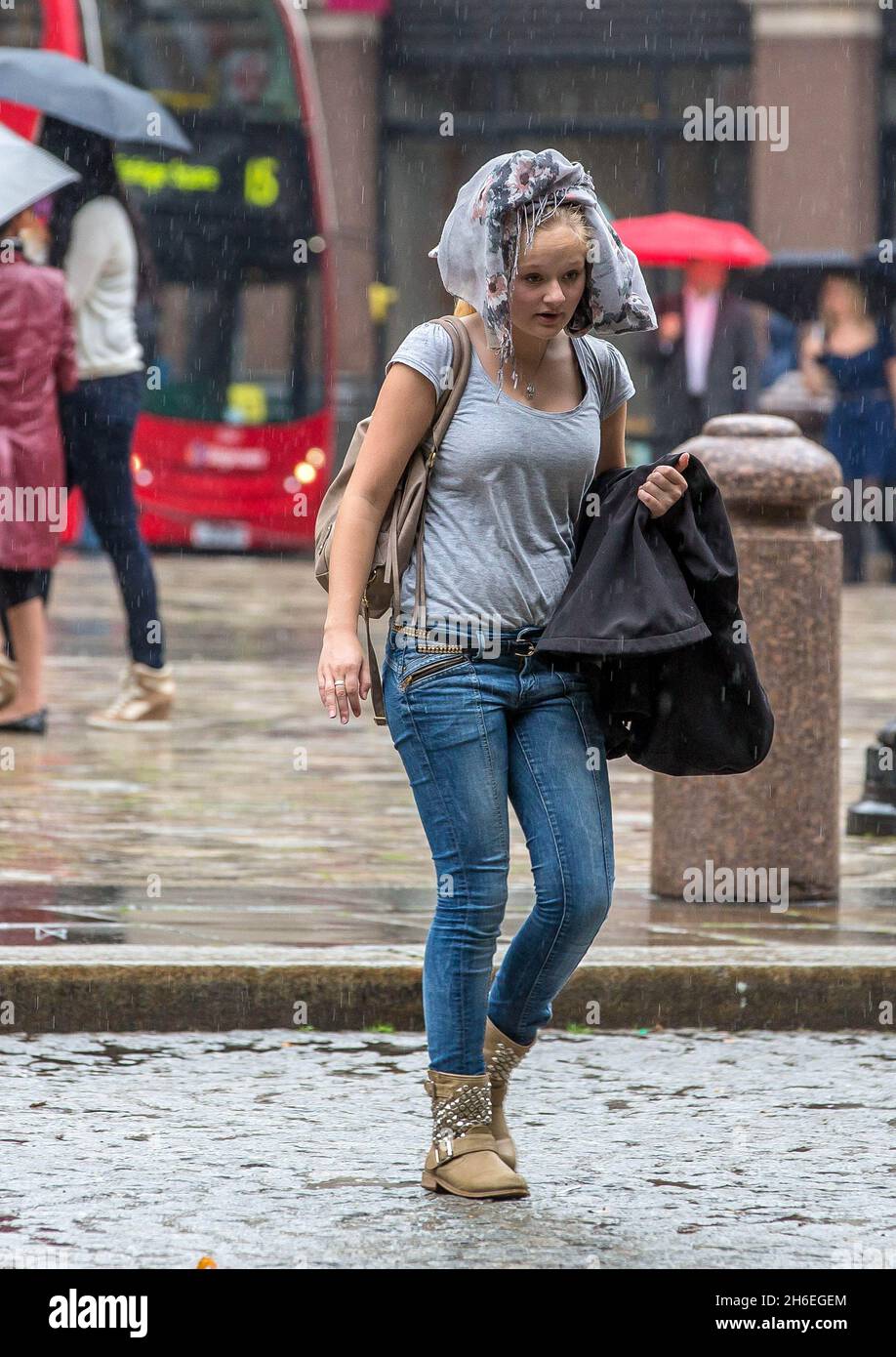 Office workers and tourists are pictured in the rain outside St Paul's ...