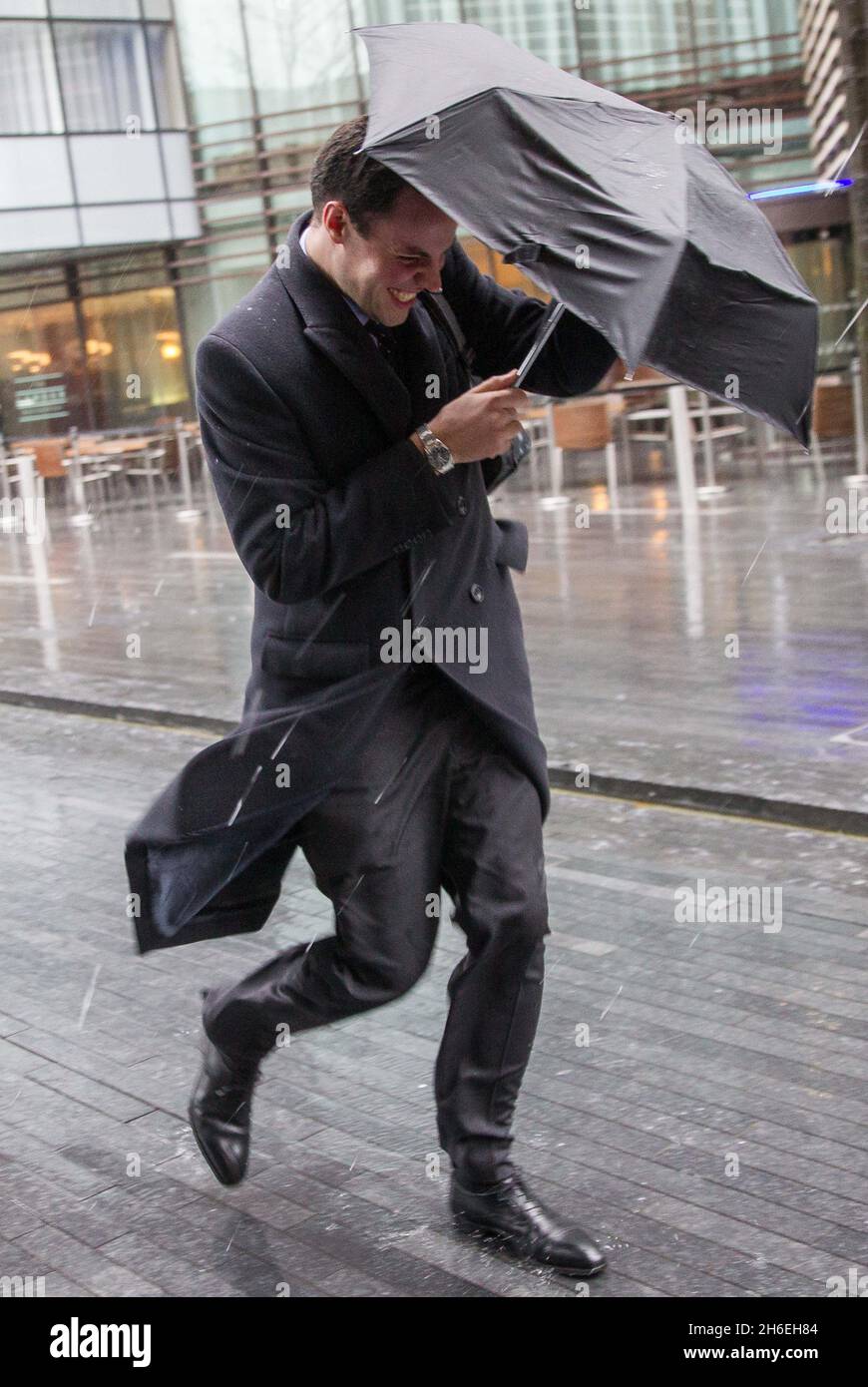 Commuters pictured in the wind and rain in central London this ...