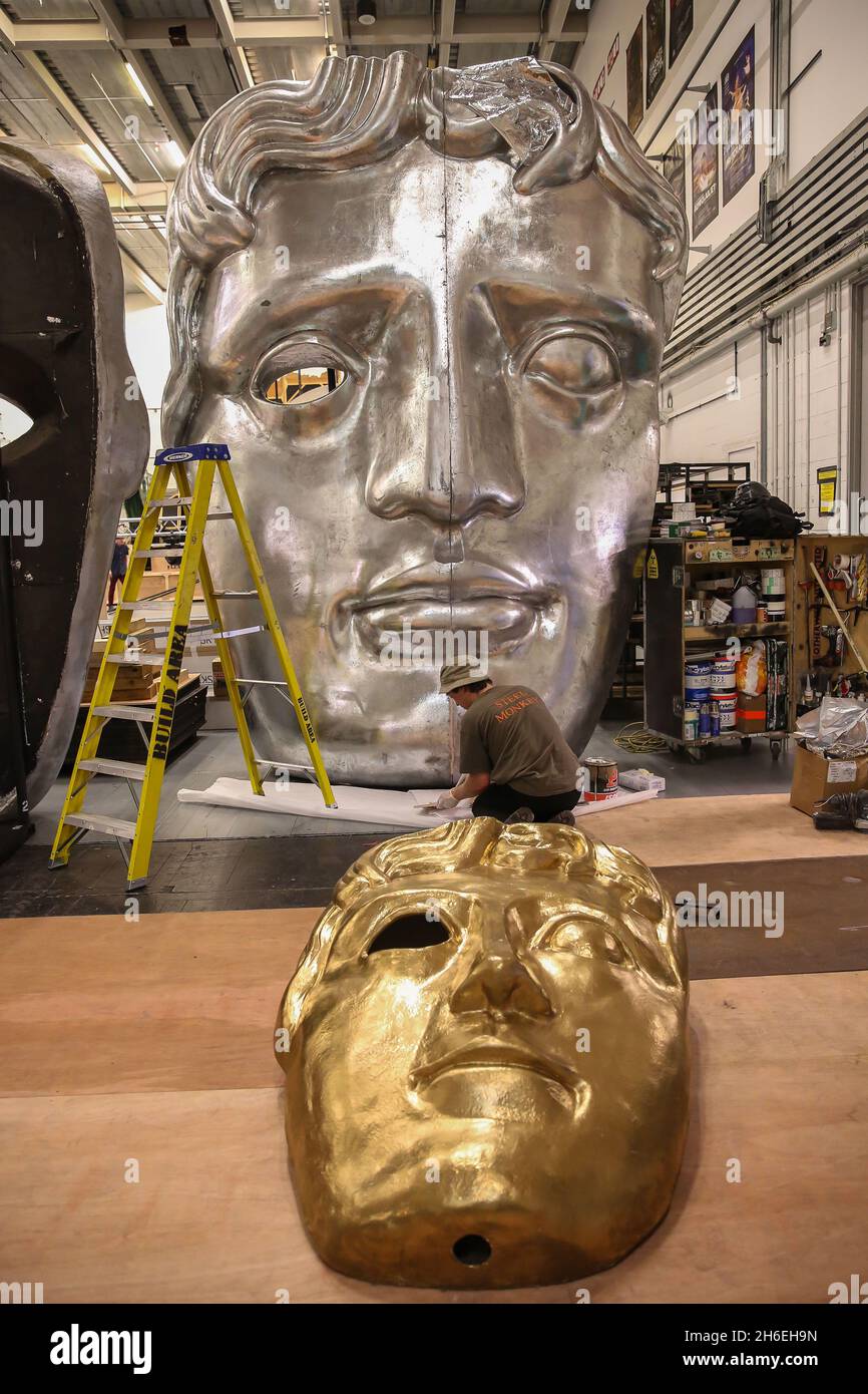 Stage crew at t the Royal Opera House work on the giant BAFTA masks ...