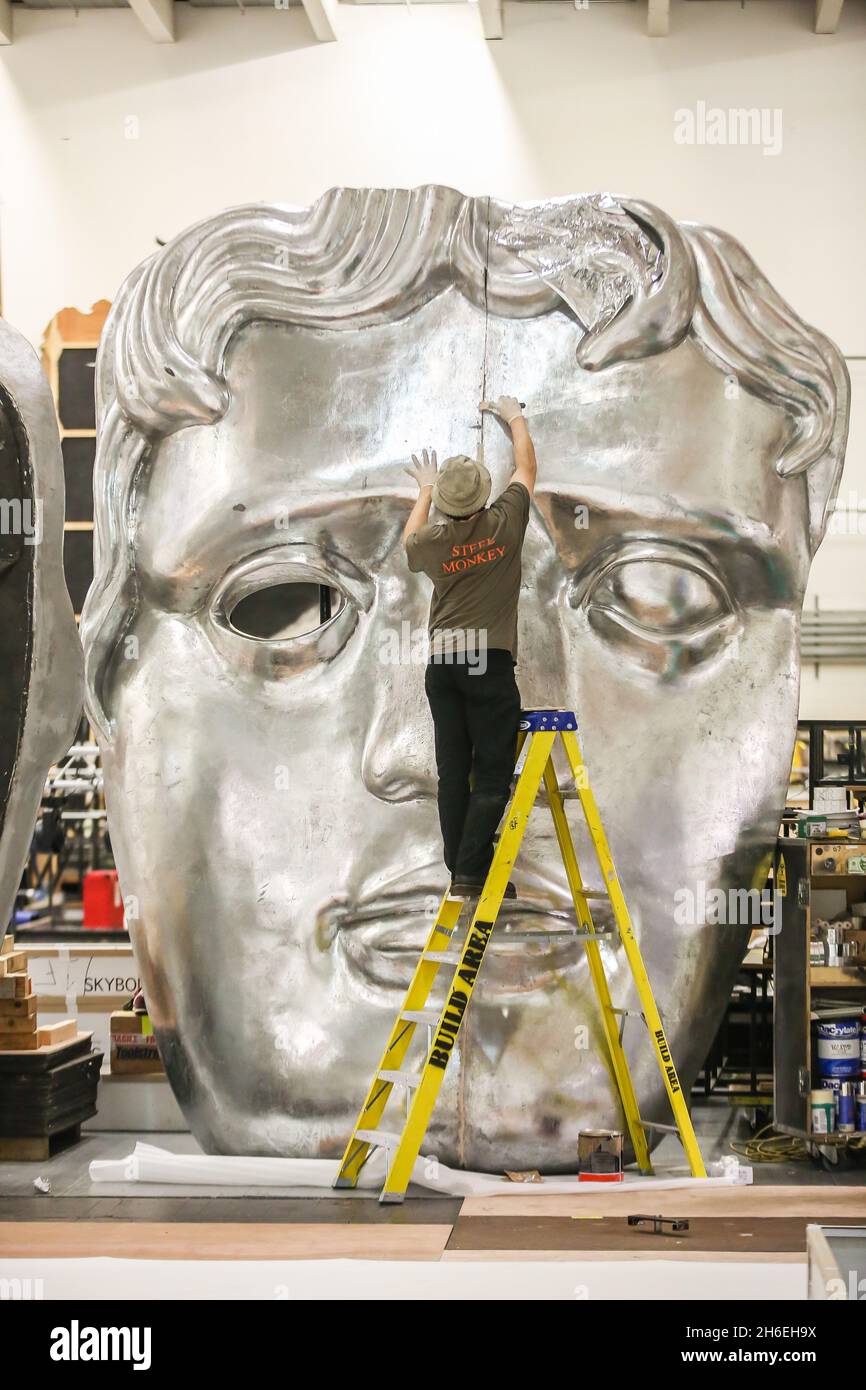 Stage crew at t the Royal Opera House work on the giant BAFTA masks ...