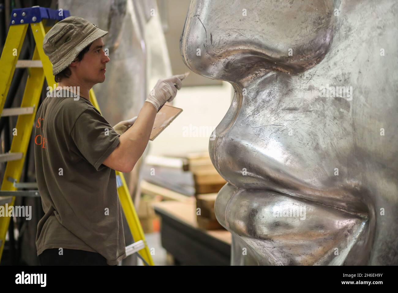 Stage crew at t the Royal Opera House work on the giant BAFTA masks ...