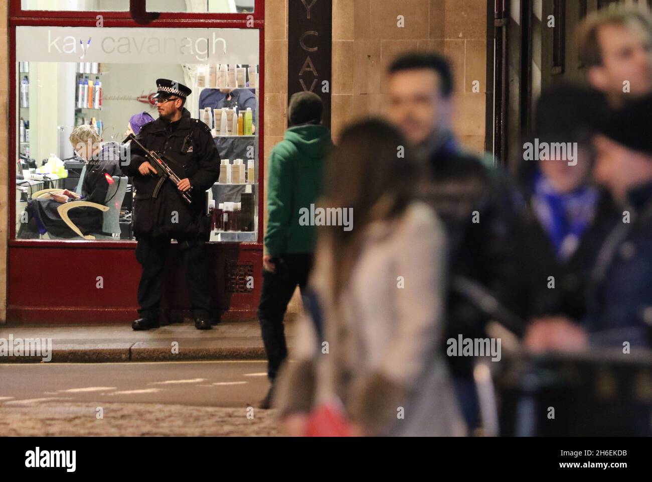An armed police officer is seen in a Mayfair street in central London ...