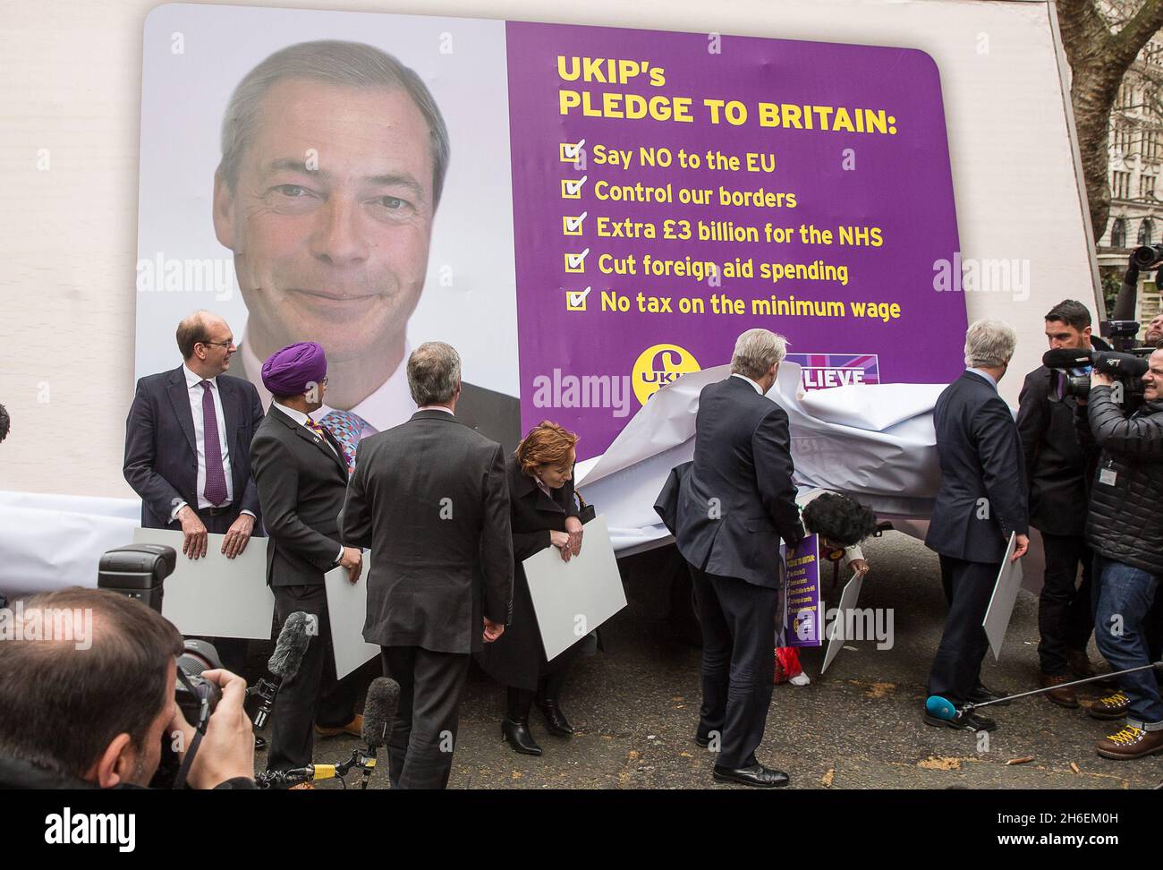 UKIP workers get caught up in the poster unveiling as Nigel Farage kick ...