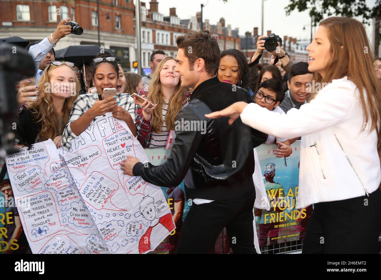 Zac Efron signs autographs for fans as he arrives for the European film ...