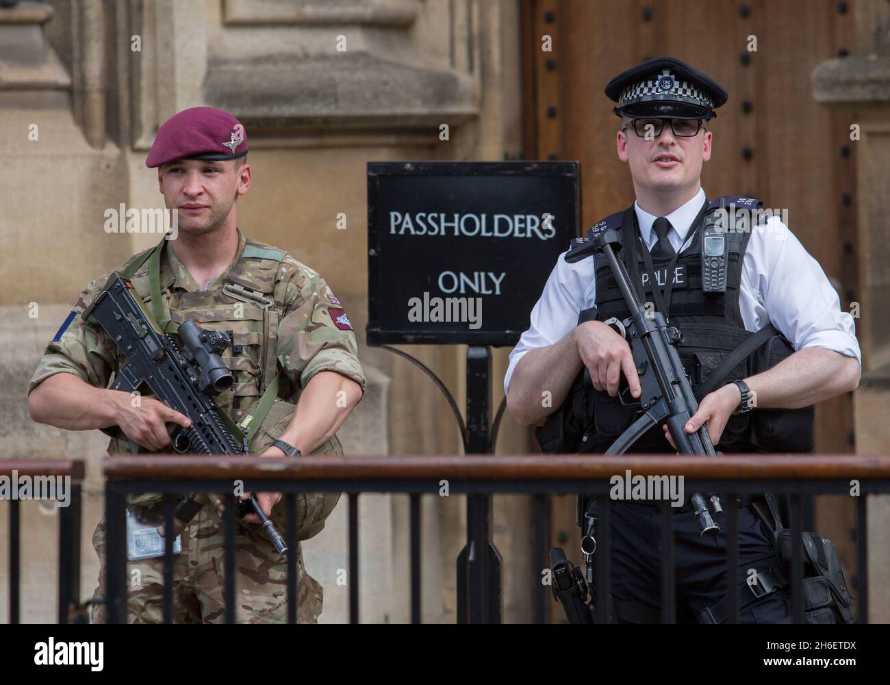 A Para soldier and armed police officers pictured guarding the House of ...