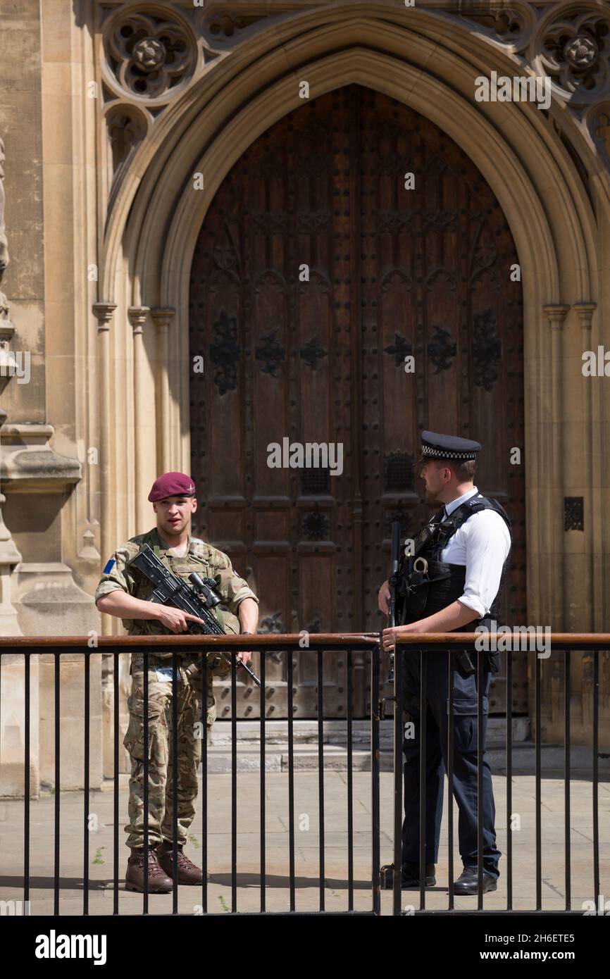 A Para soldier and armed police officers pictured guarding the House of ...